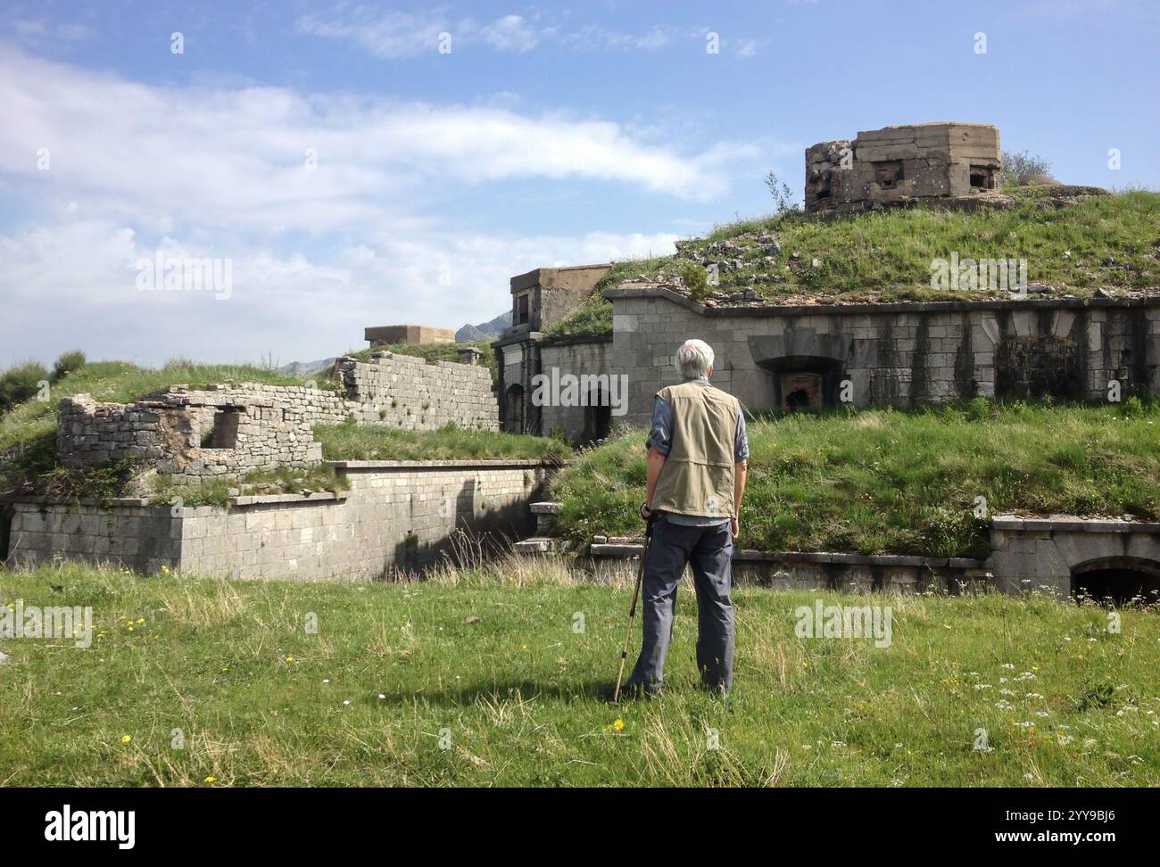 Senior man looking at ruins of 19th century Austro-Hungarian Empire ...