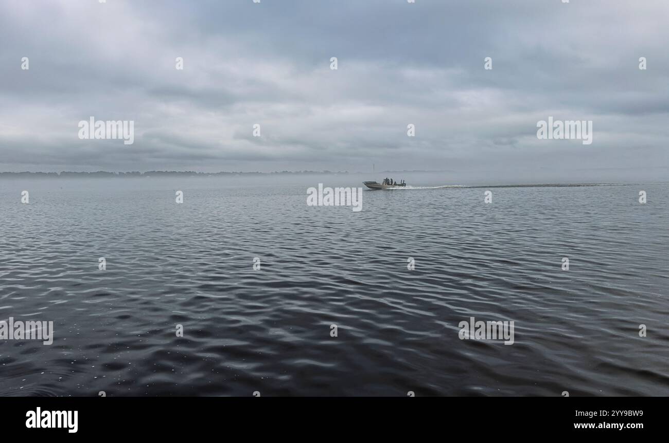 A boat heads into shore from fishing on a Foggy afternoon on the Neuse ...