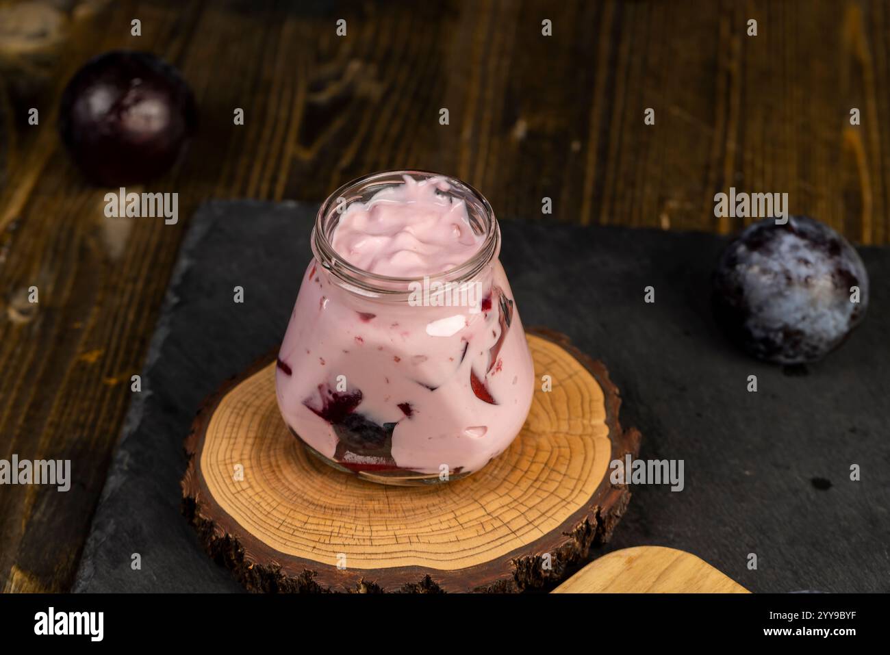 plum and plum-flavored yogurt, plum yogurt with slices and whole fruits ...