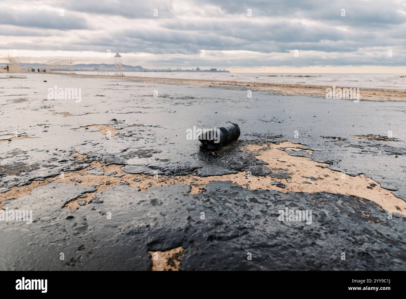 Oil in ocean coastline after a tanker wreck. The beach is polluted with ...