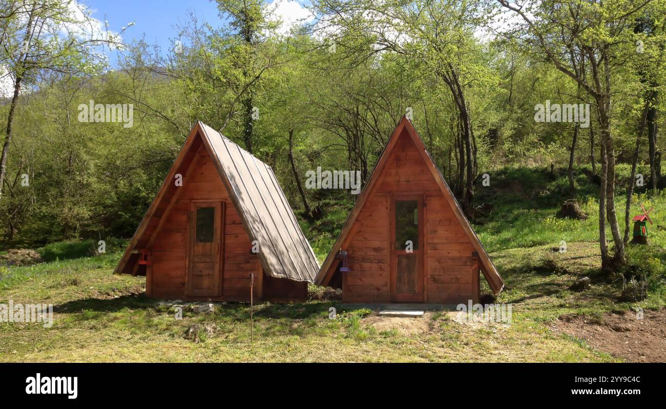 Small wooden tourist accommodation cabins in forest, Camp Highlander ...