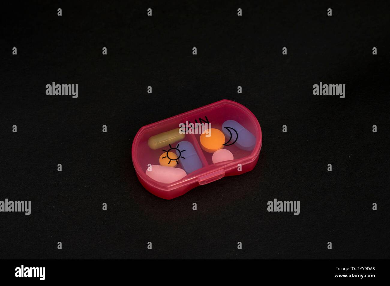 Compact pink pill organizer box with dual compartment of day and night ...