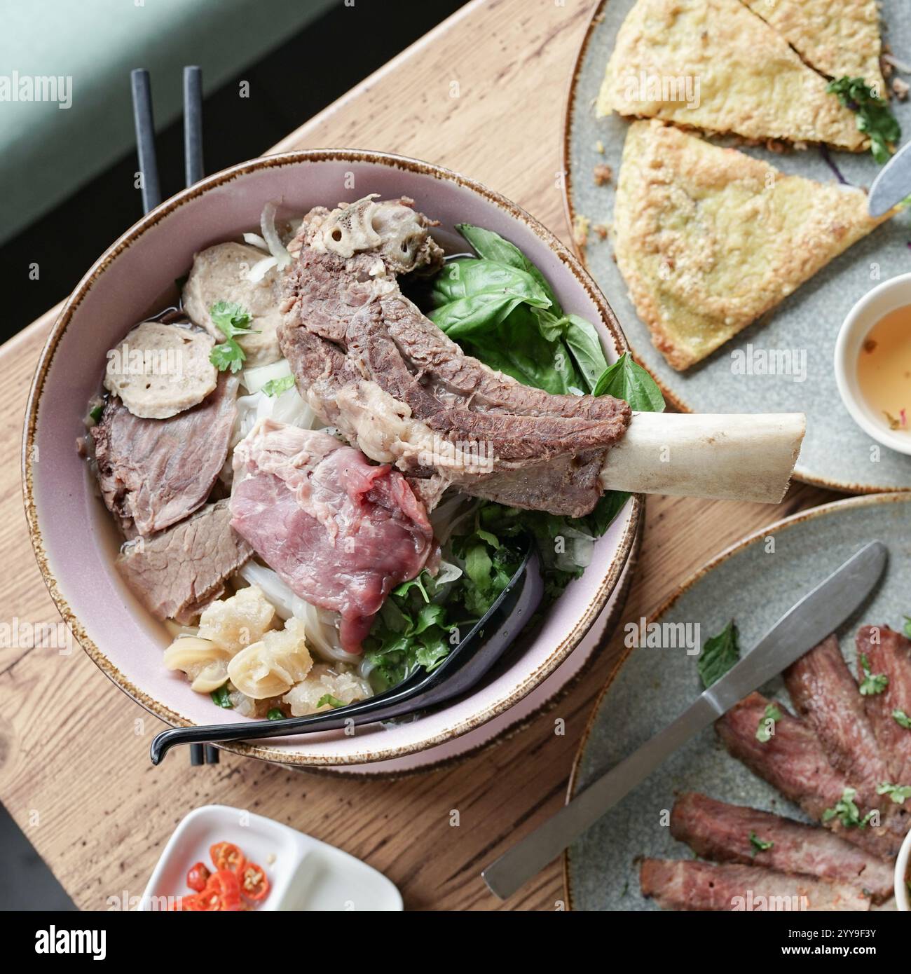 An indulgent bowl of Vietnamese pho bo featuring a giant tender beef ...