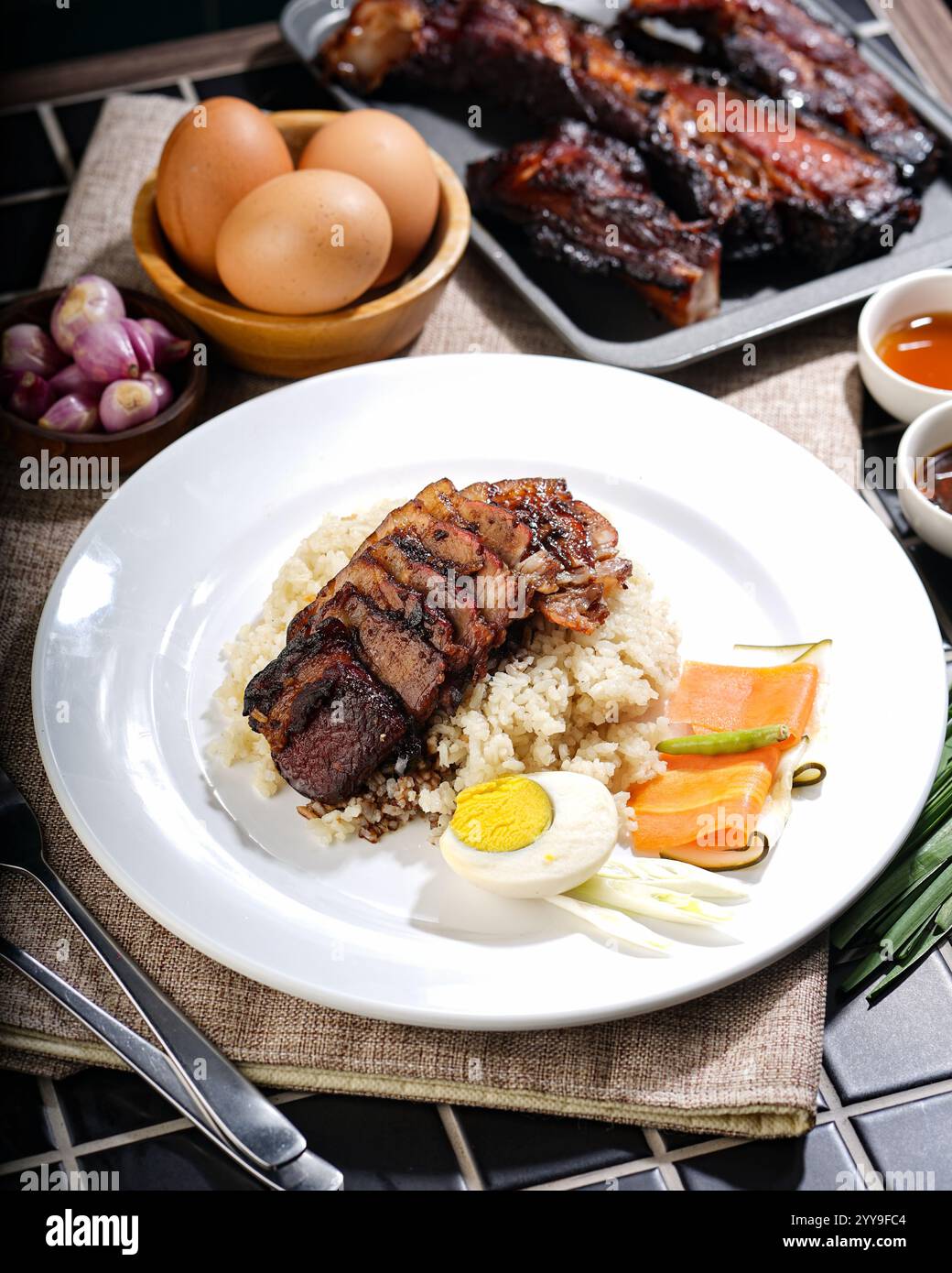 A traditional Asian roasted duck rice dish served with pickled ...