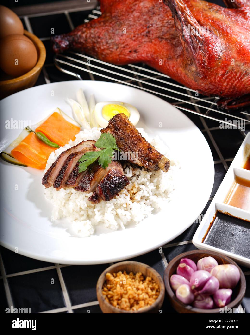 A traditional Asian roasted duck rice dish served with pickled ...