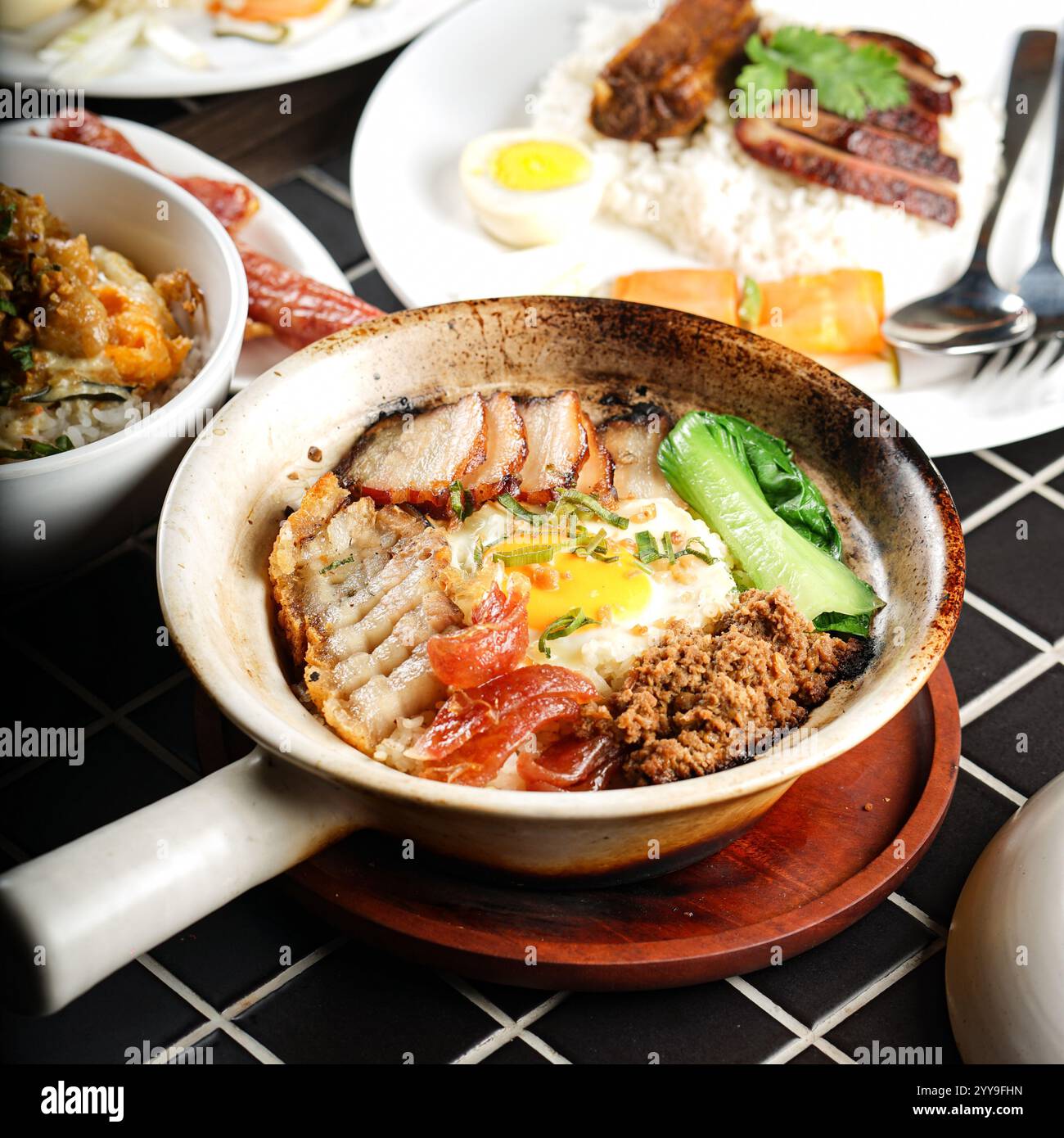 Traditional clay pot rice served with a variety of savory toppings ...