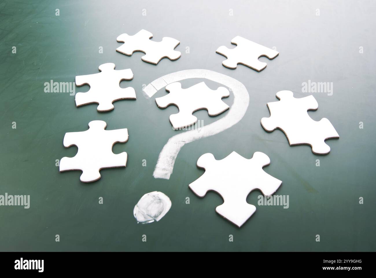 Question mark and puzzle pieces on blackboard Stock Photo - Alamy