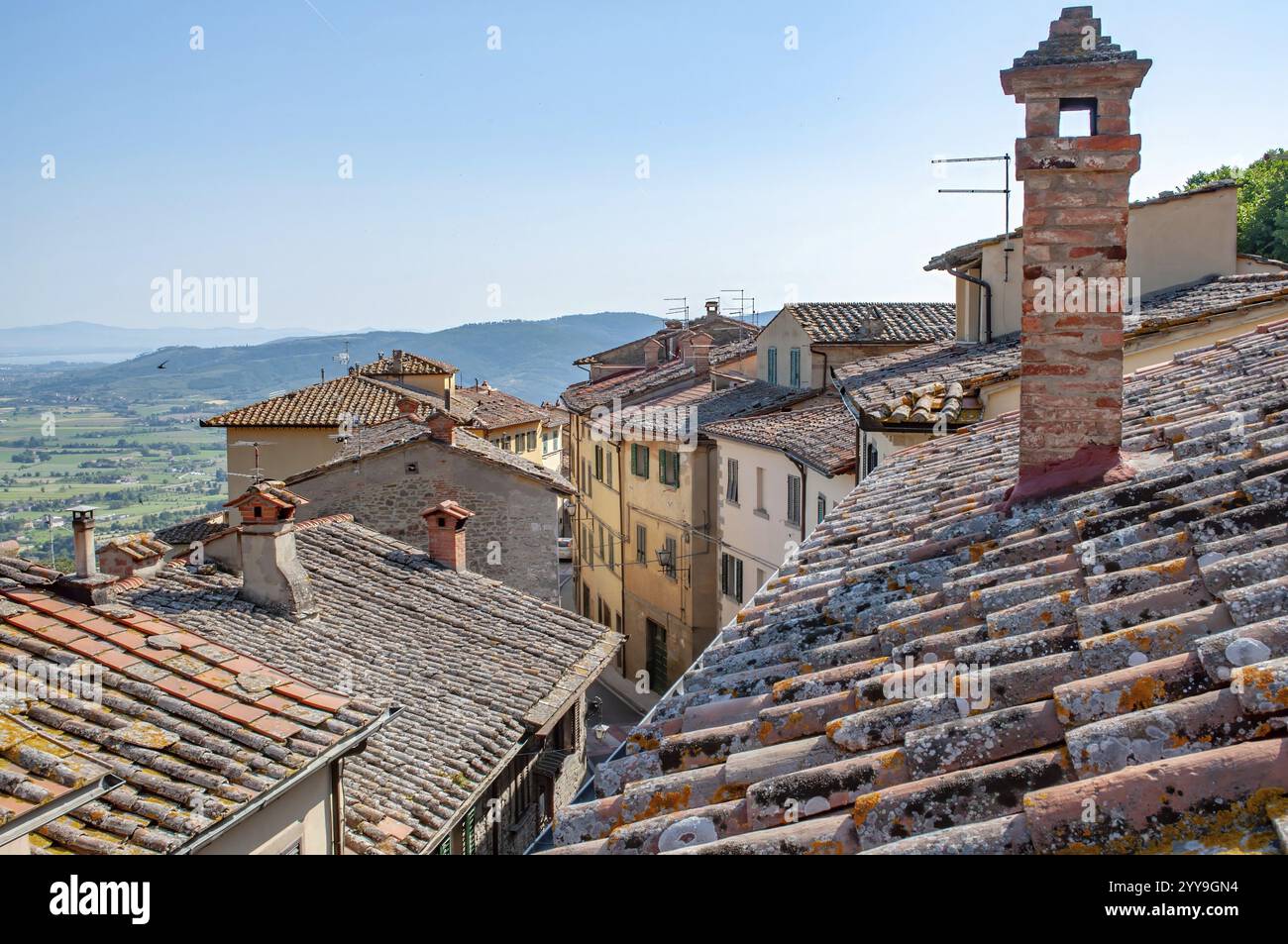 Picturesque italian village showing terracotta roofs and brick chimneys ...