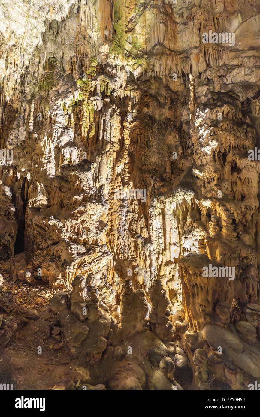 Breathtaking view of illuminated stalactites and stalagmites formations ...