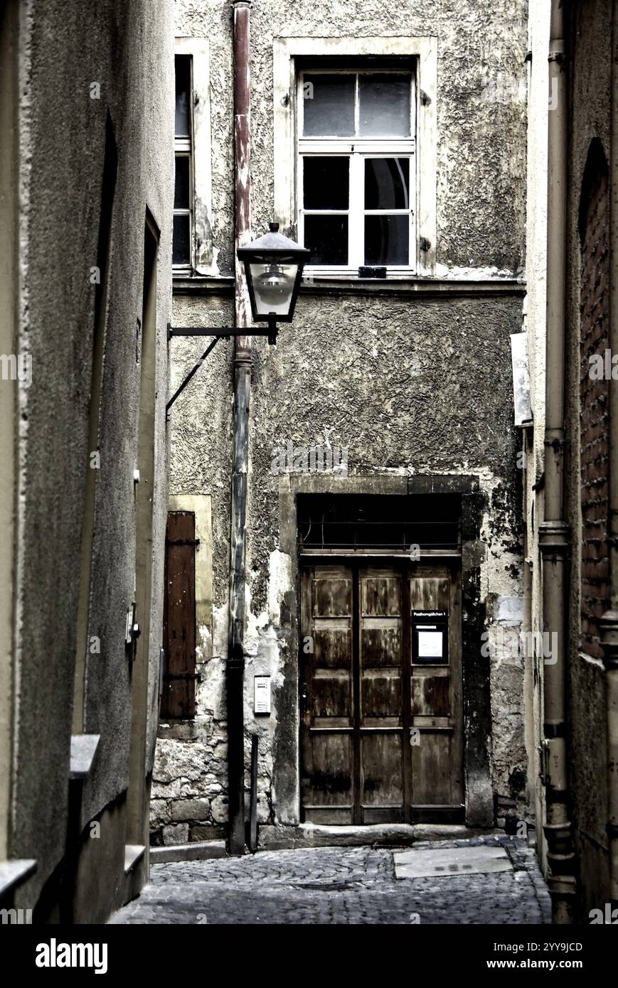An old alley in Regensburg. Old house in small alleyway with lantern ...