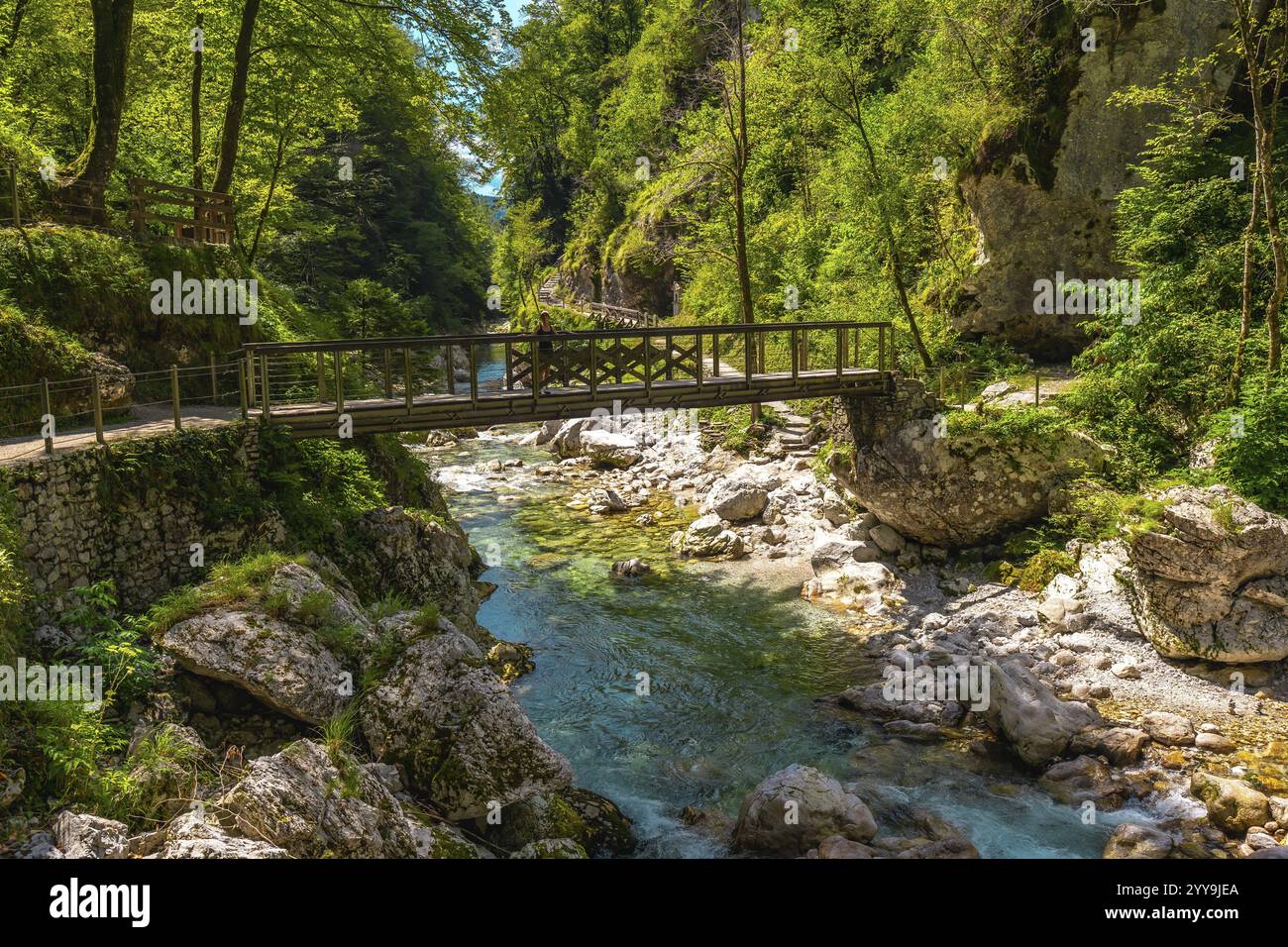 Turquoise water flowing under wooden bridge over tolmin gorges in ...