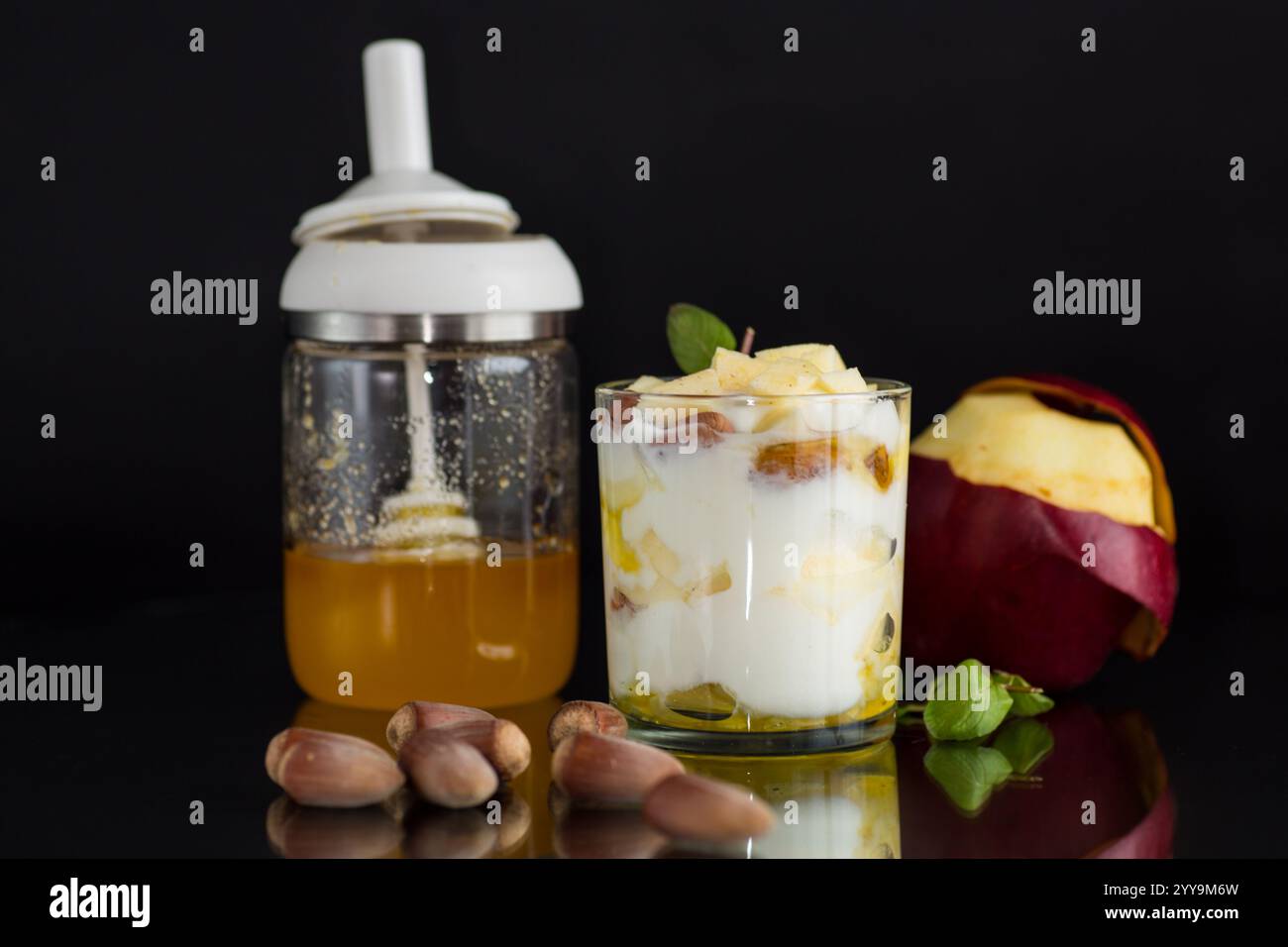 sweet homemade yogurt in a glass with apples, nuts and honey Stock ...