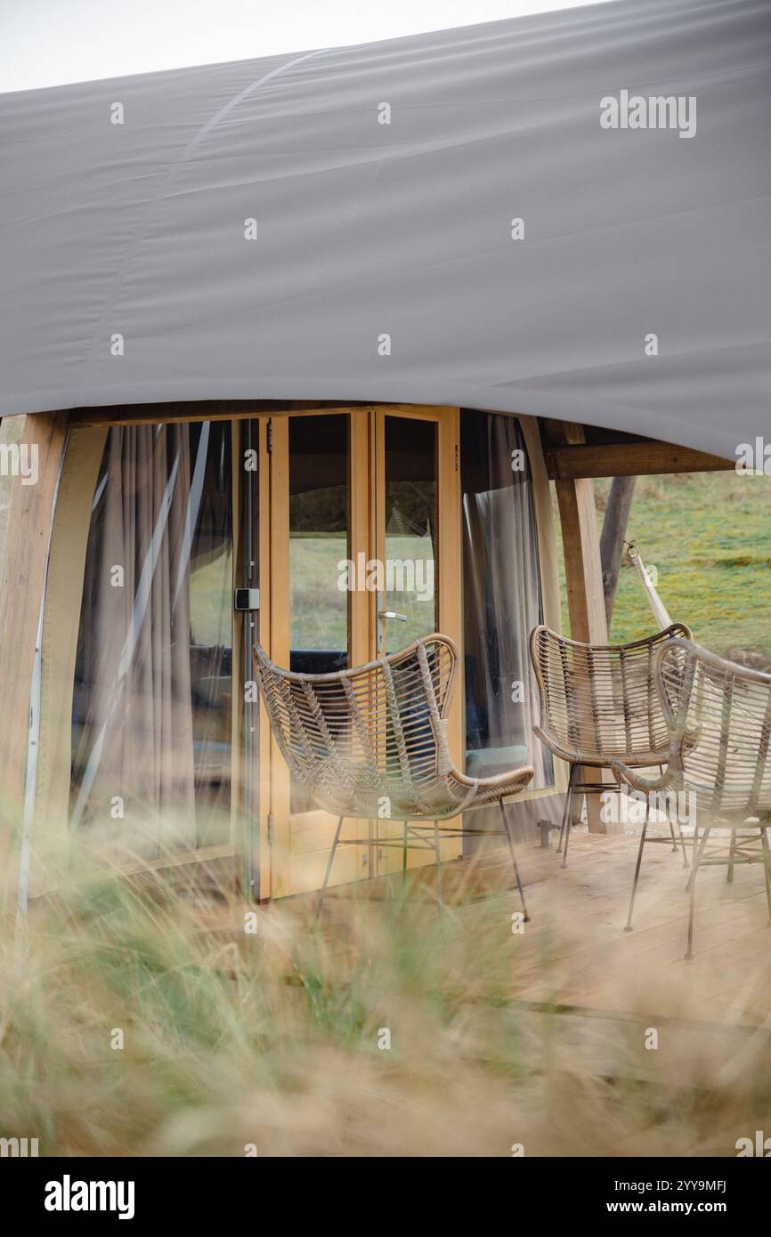 the outdoor leisure terrace with chairs in a glamping tent with blurry ...