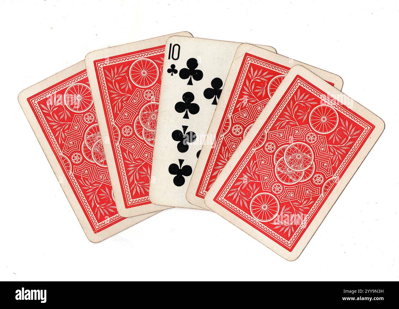 A hand of vintage playing card backs with the ten of clubs revealed on ...