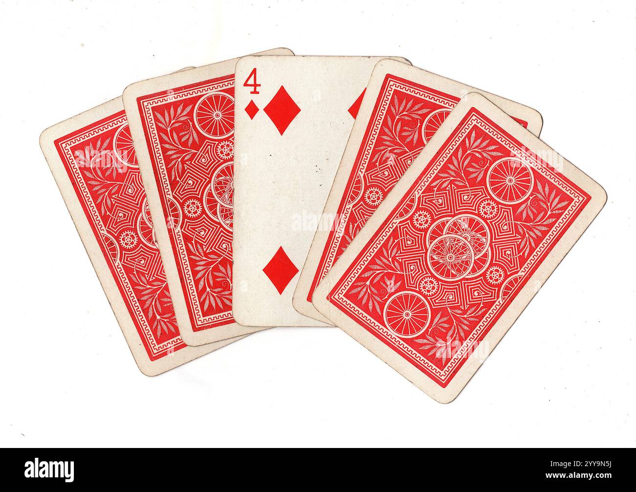 A hand of vintage playing card backs with the four of diamonds revealed ...