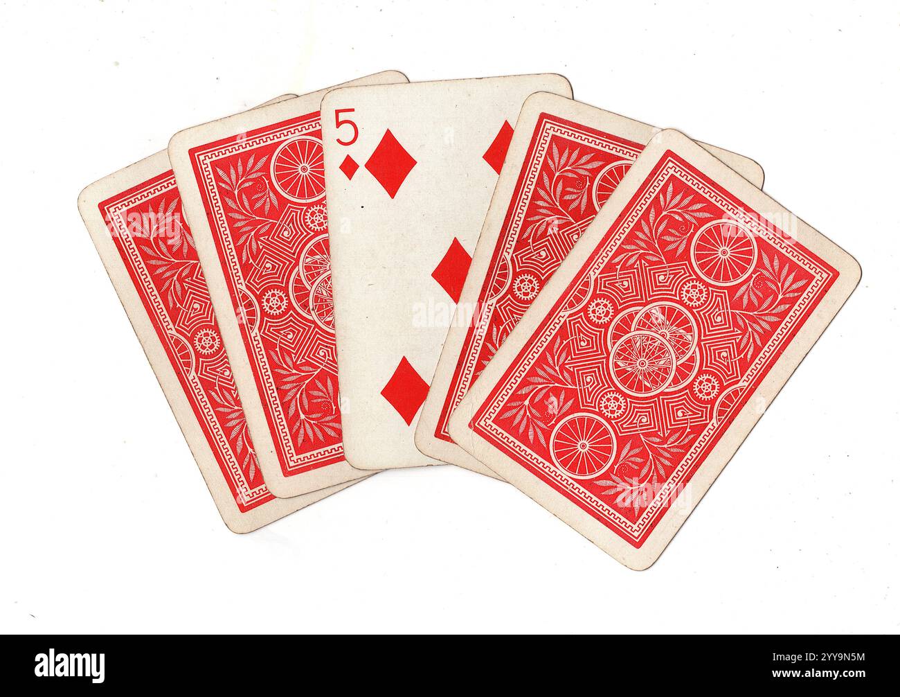 A hand of vintage playing card backs with the five of diamonds revealed ...