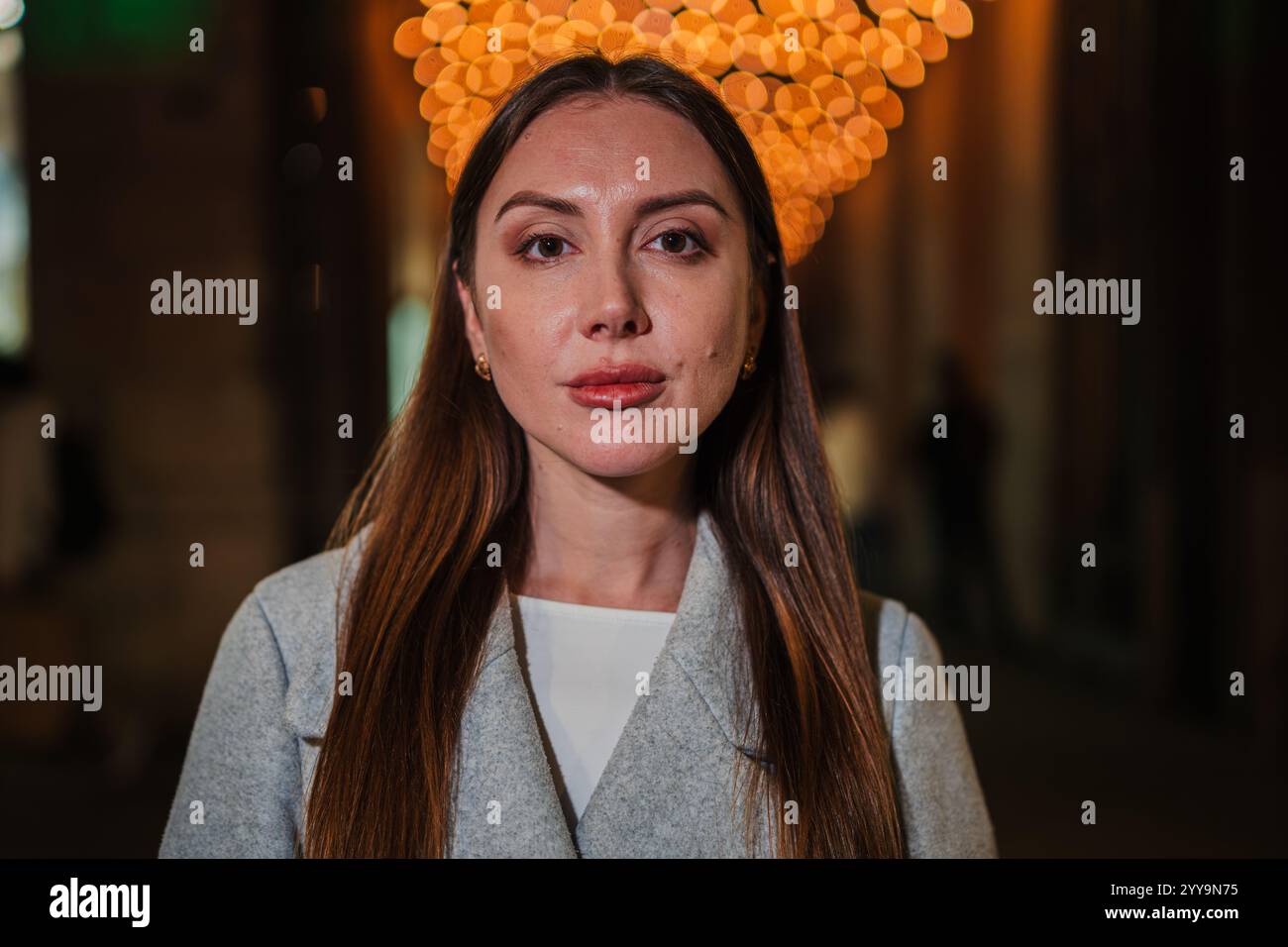 Individual portrait of a serious young woman with long hair looking ...