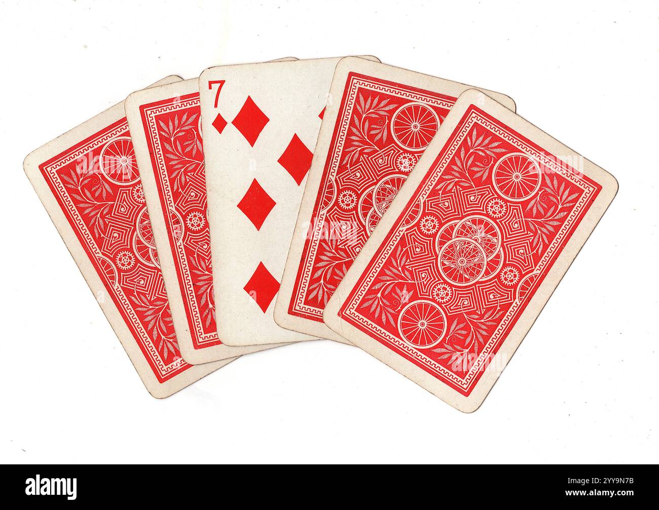 A hand of vintage playing card backs with the seven of diamonds ...