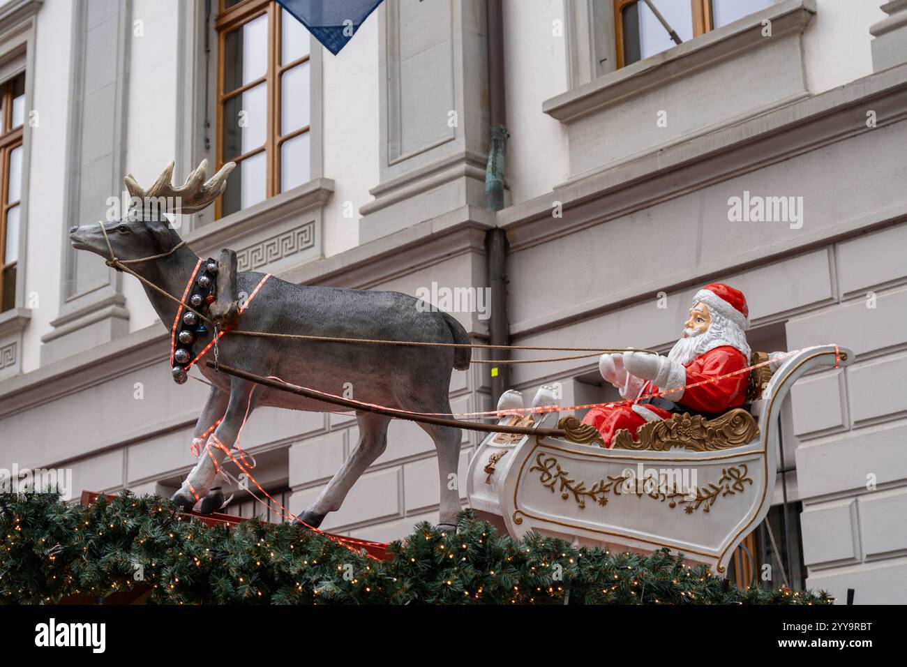 Cute Santa Claus and sleigh with reindeer decoration on top of a ...