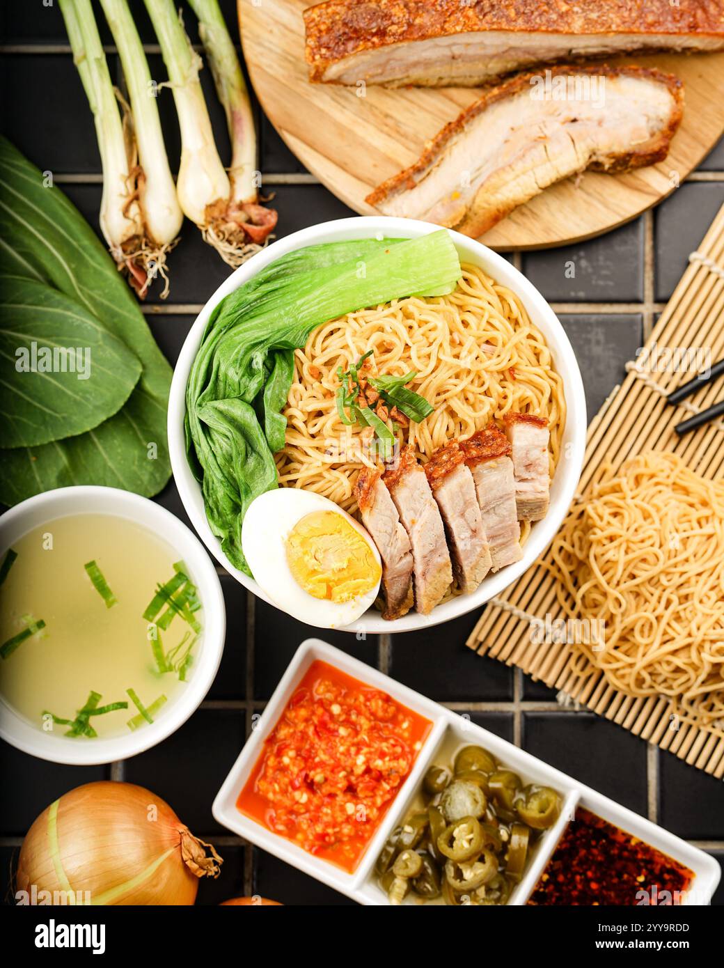 A flavorful bowl of Filipino-style dry egg noodles topped with crispy ...