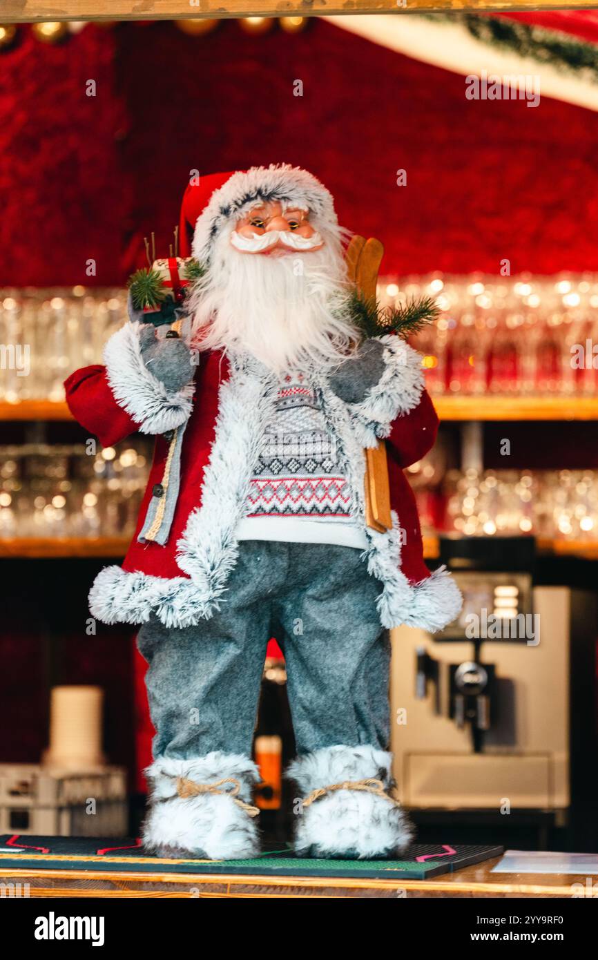 Fun Santa Claus with skiing equipment decoration at a Christmas market ...