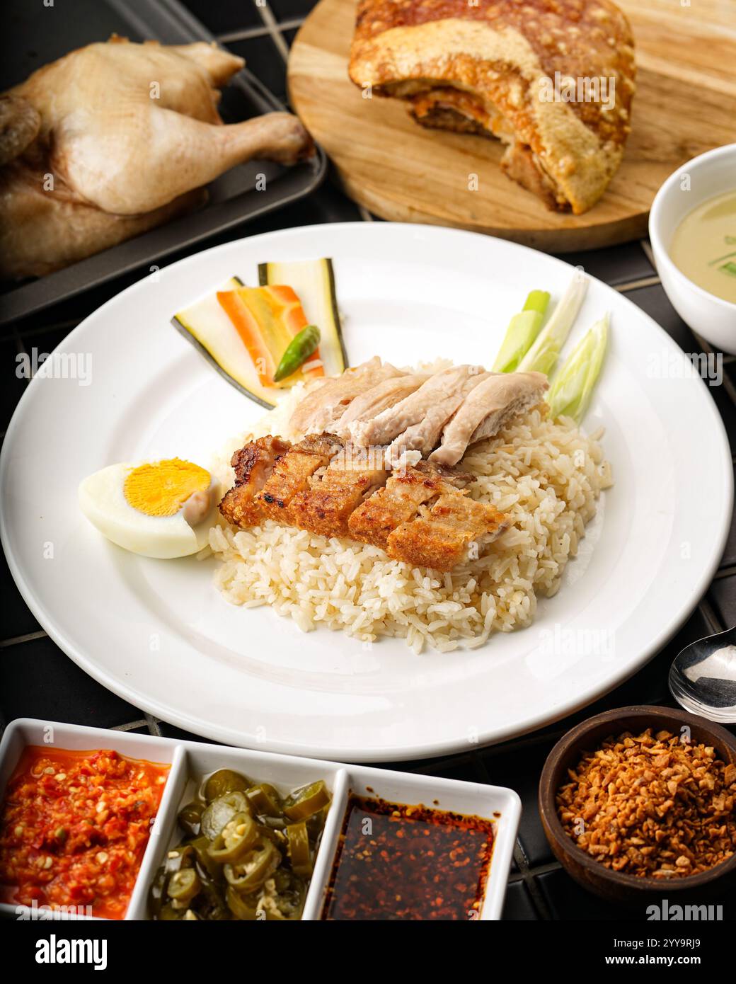Traditional Hainanese chicken rice featuring both roasted and poached ...