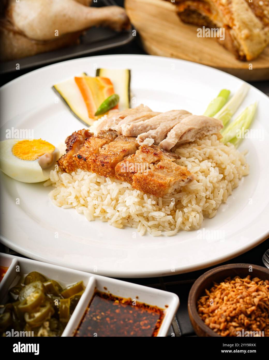 Traditional Hainanese chicken rice featuring both roasted and poached ...