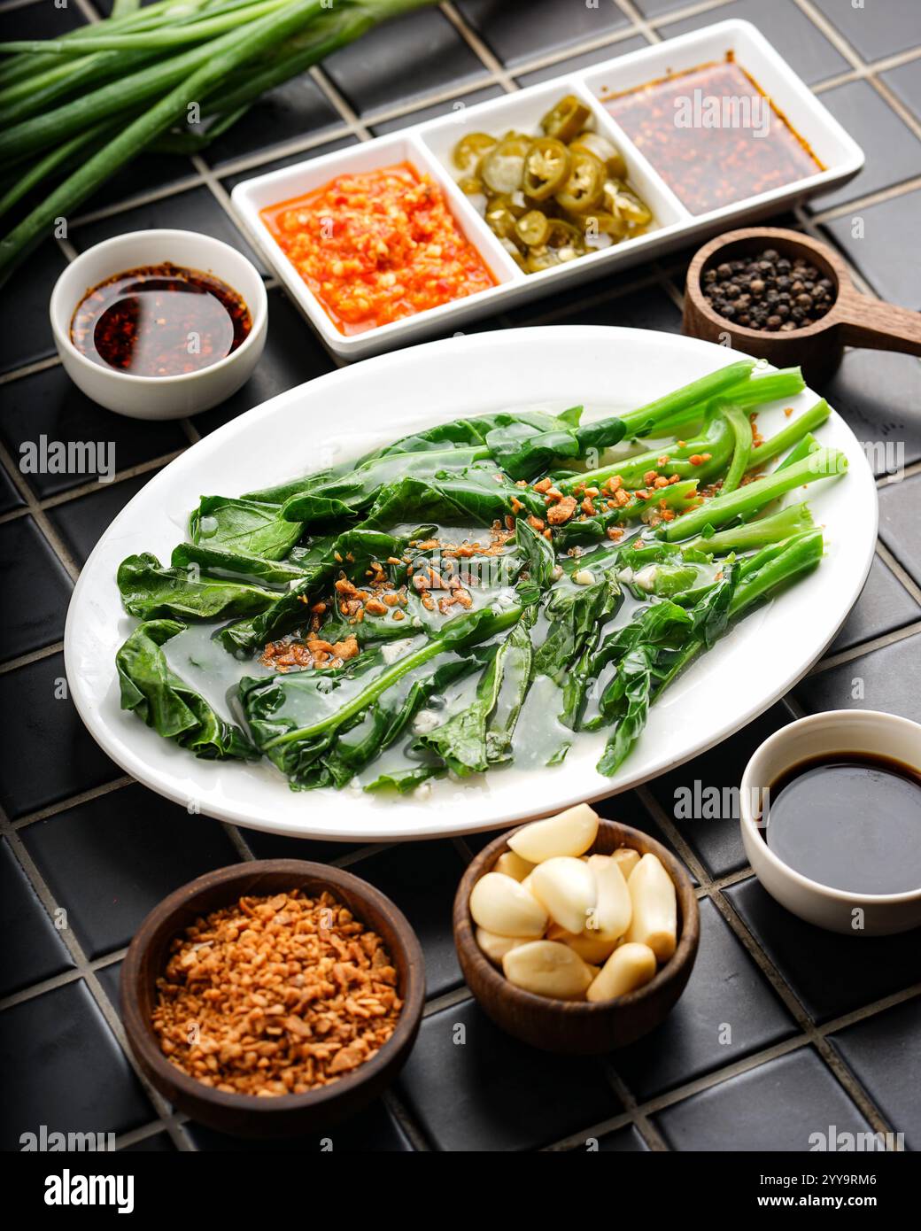 Steamed Chinese kale (kai lan) served with crispy garlic and ...
