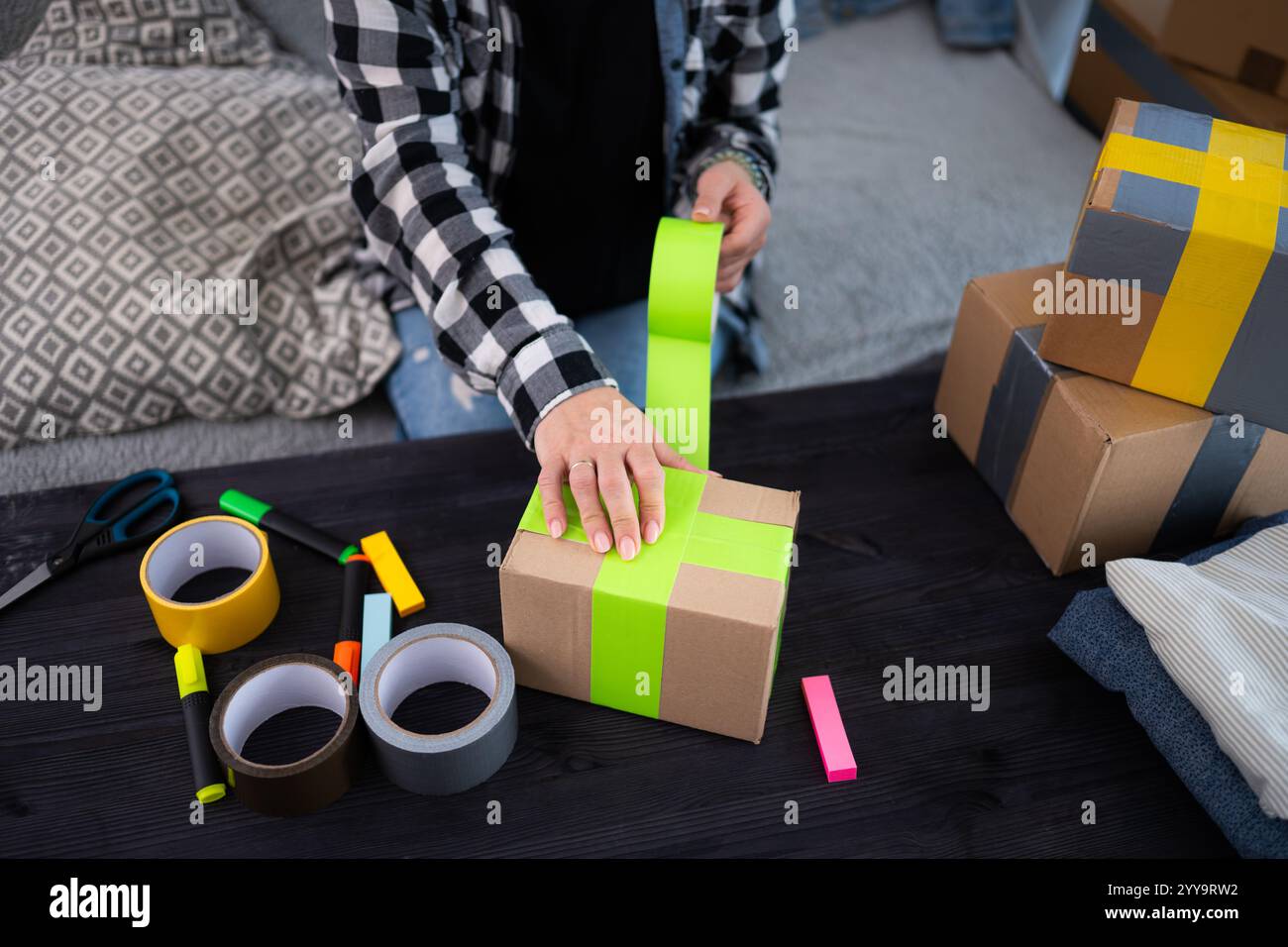 Girl Packing A Cardboard Box At Home And Preparing Packages For ...