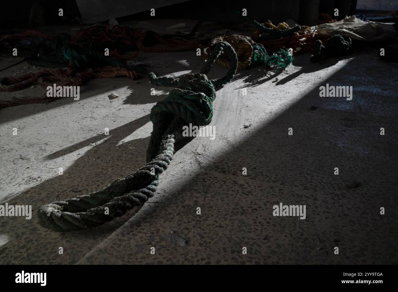 A rope tied in the shape of noose lies on the floor of a room at the ...