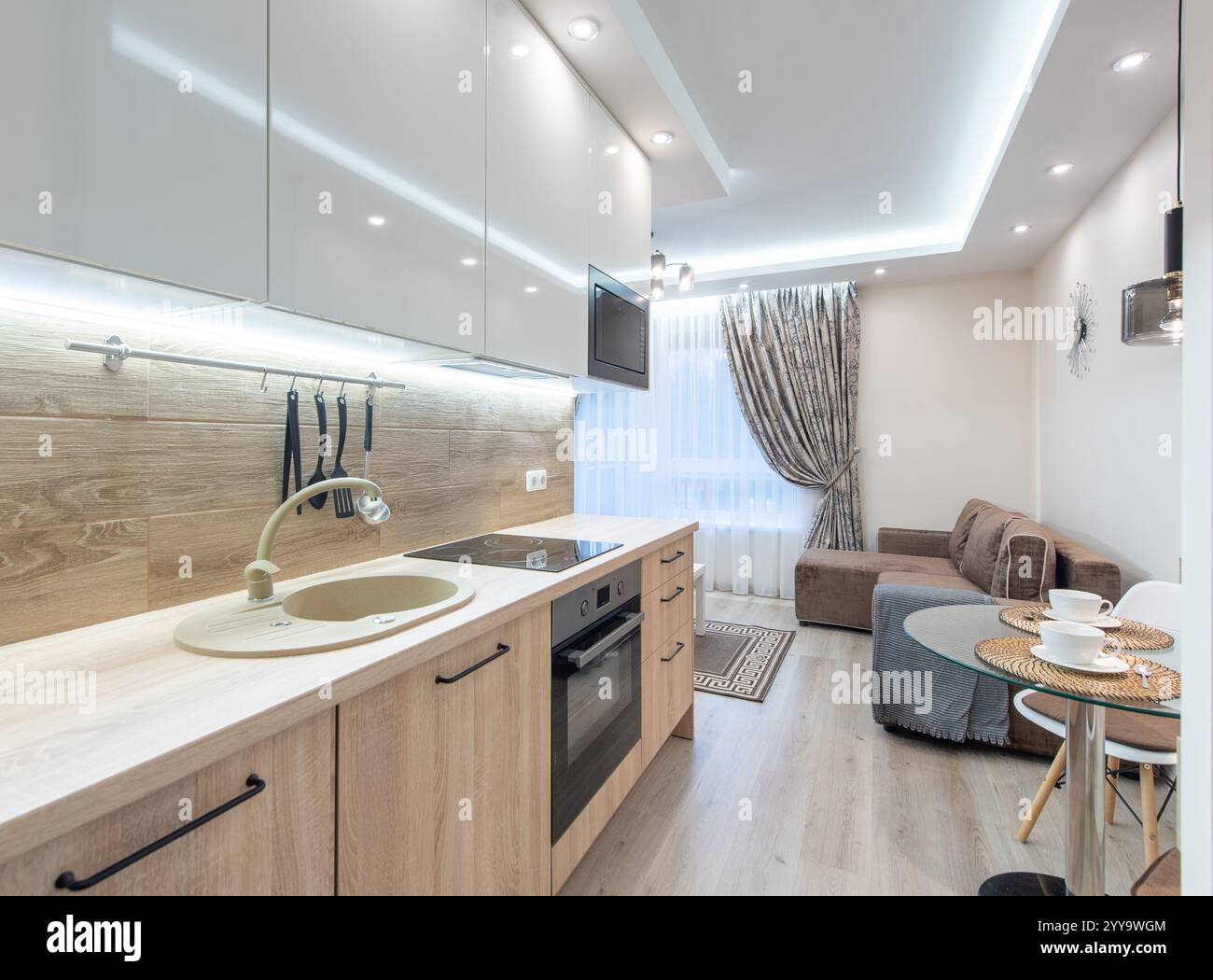 Bright and modern kitchen interior featuring wooden cabinets ...