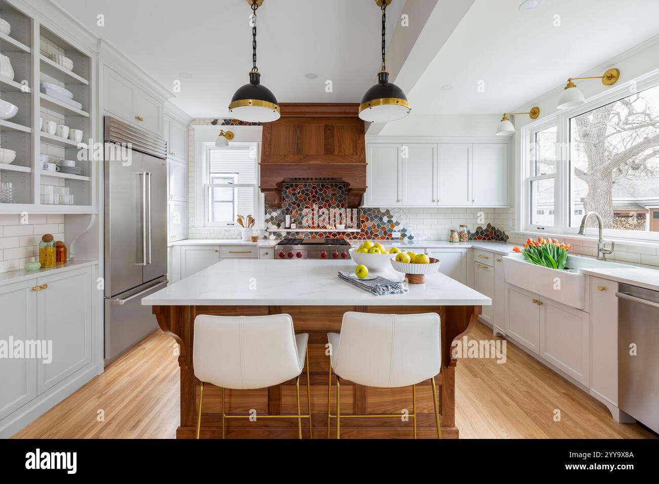 View of walnut kitchen island toward range and walnut hood with other ...