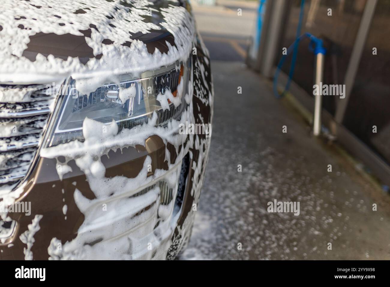 Washing luxury car on a touchless car wash. Washing sedan car with foam ...
