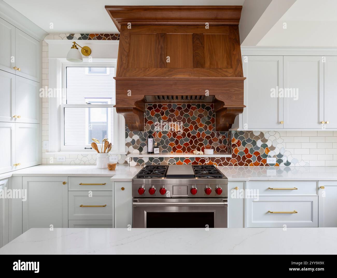 Kitchen wall featuring Wolf range, walnut hood and colorful tile ...