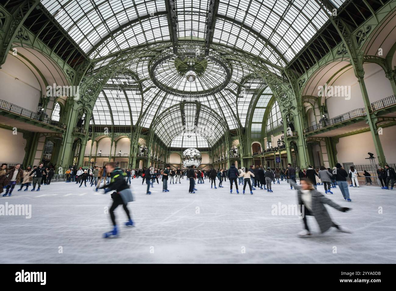 Paris, France. 20th Dec, 2024. Skating enthusiasts skate at a huge ice skating rink at the Grand ...