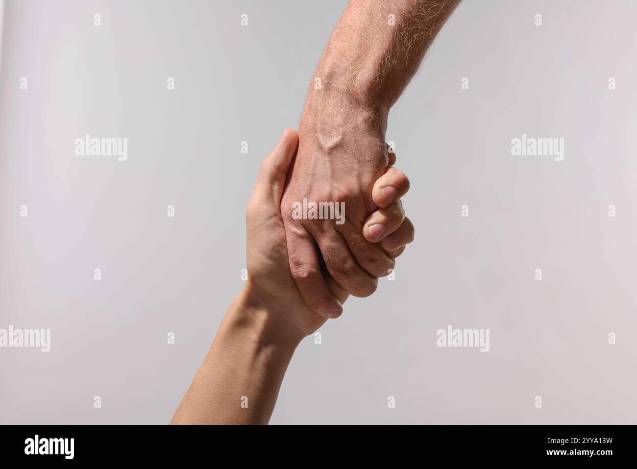 Help and support. People holding hand on light grey background, closeup ...