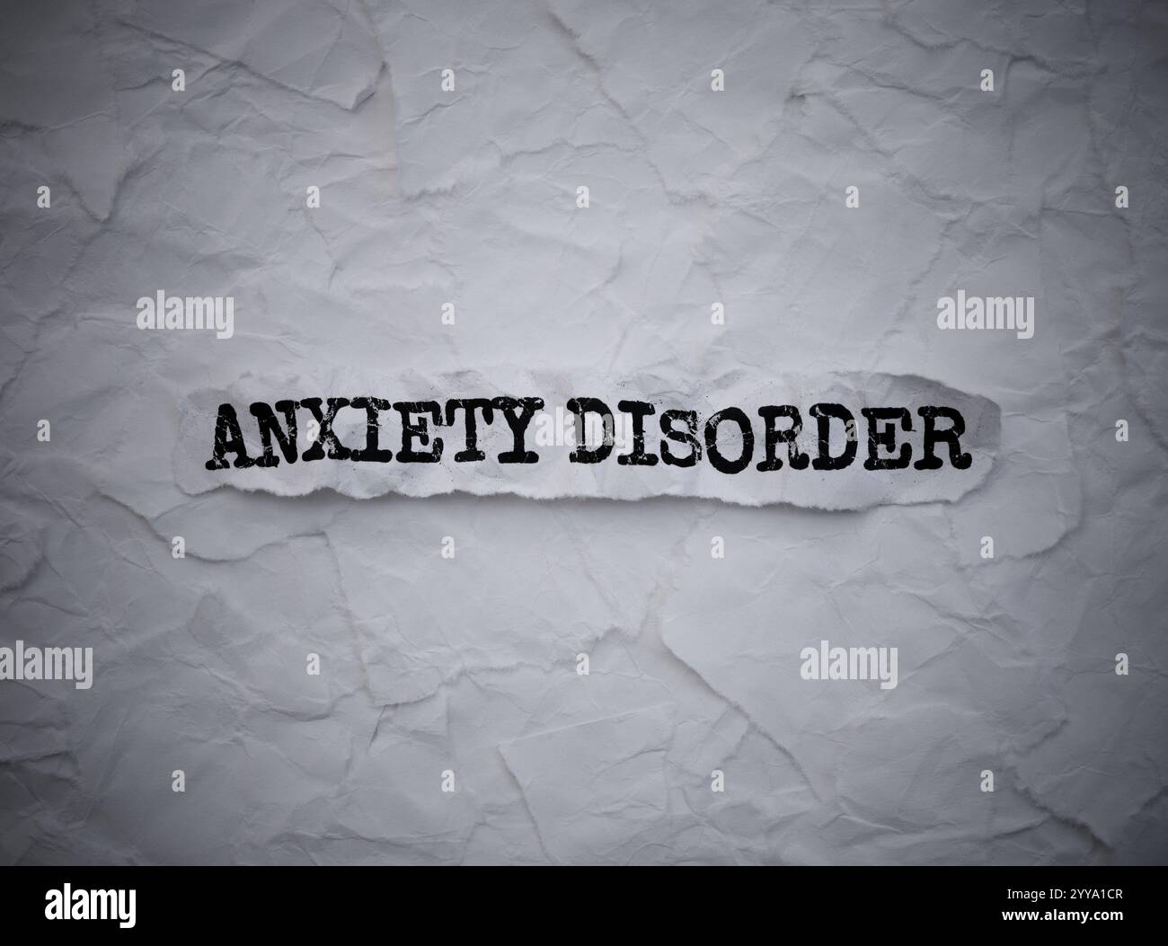 Crumpled piece of paper with words Anxiety Disorder on torn white paper ...