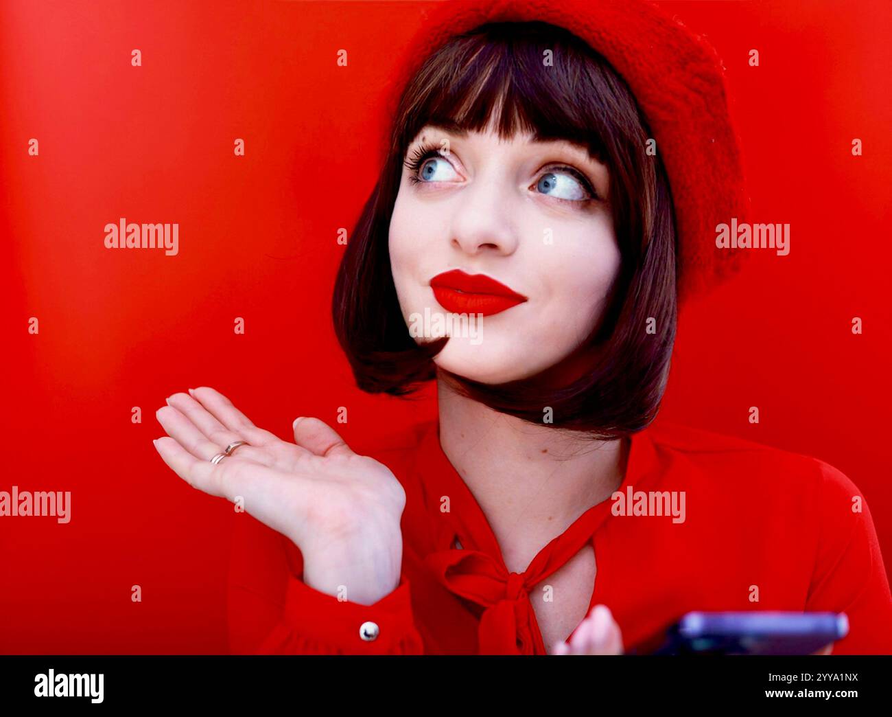 a girl with a bob hairstyle is holding a bilge in her hands. The girl ...