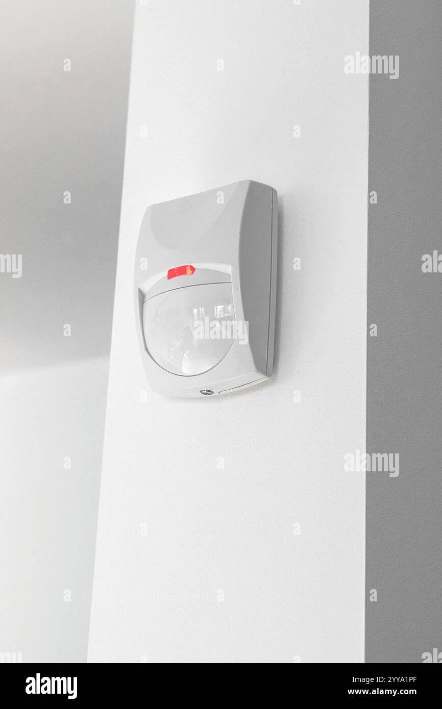 Safety system. Motion sensor of the security system on a white wall ...