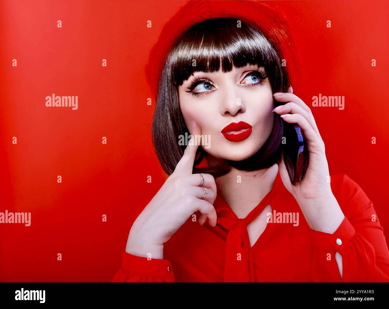 a girl with a bob hairstyle is holding a bilge in her hands. The girl ...