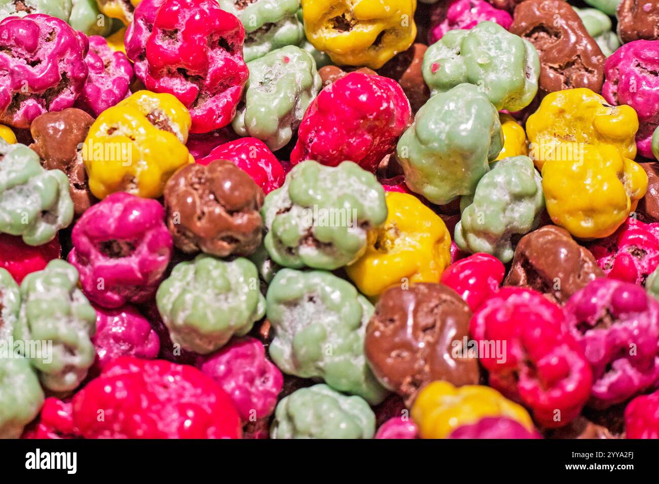 background of multi-colored candies with raisins in the shape of a ...