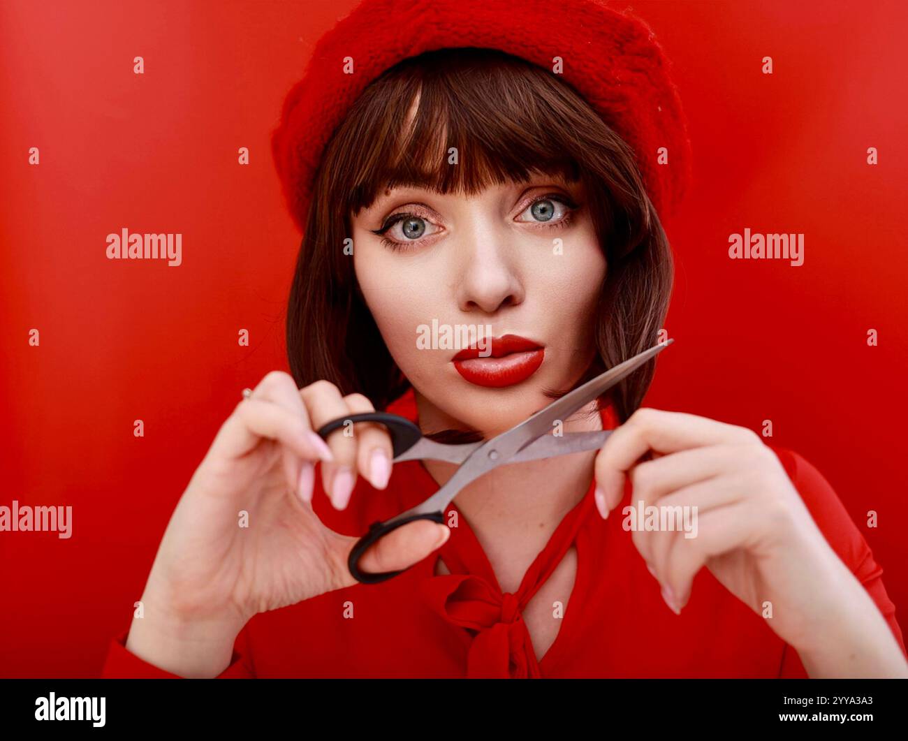 Haircut. Portrait of young woman hairdresser cutting hair with scissors ...