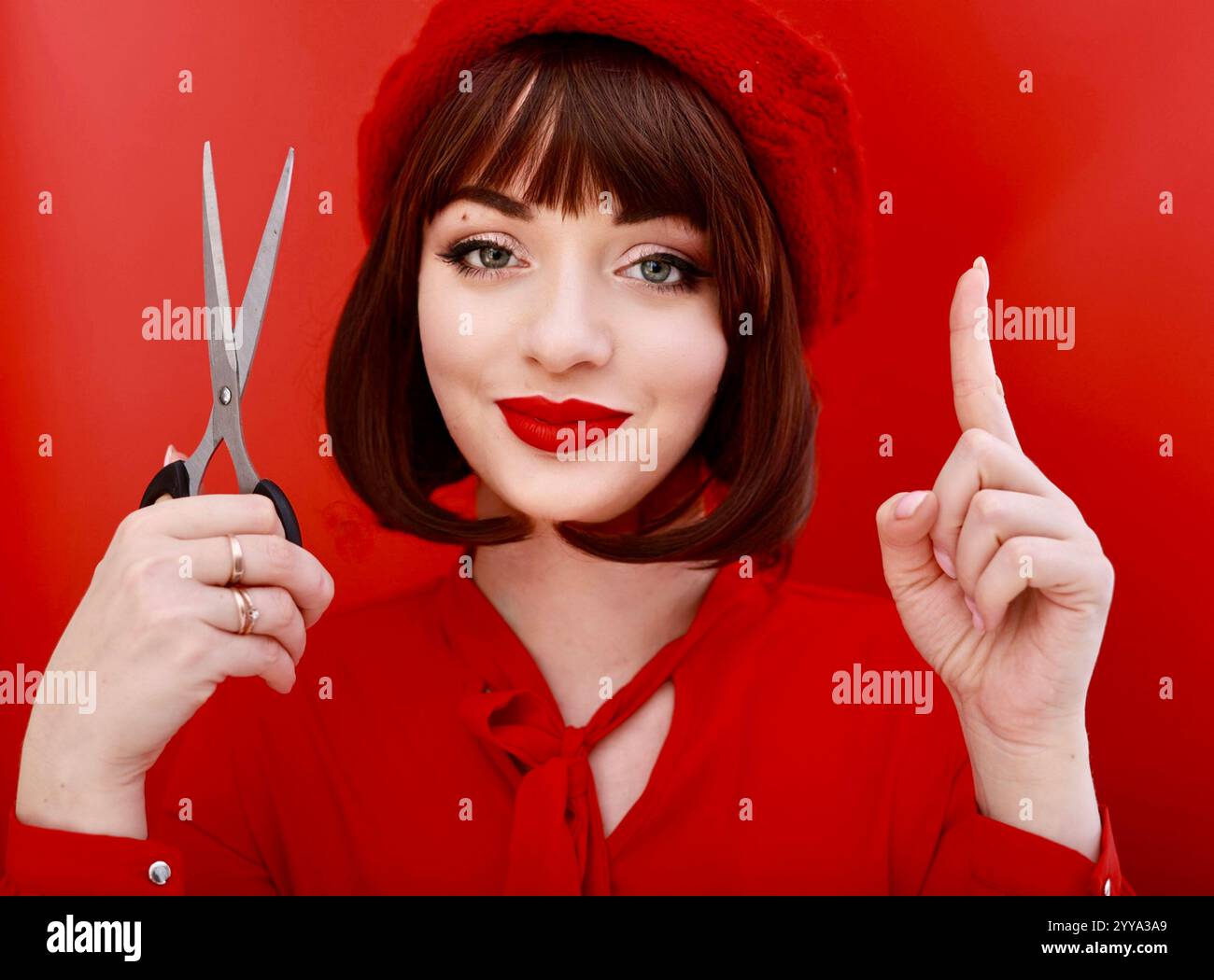 Haircut. Portrait of young woman hairdresser cutting hair with scissors ...
