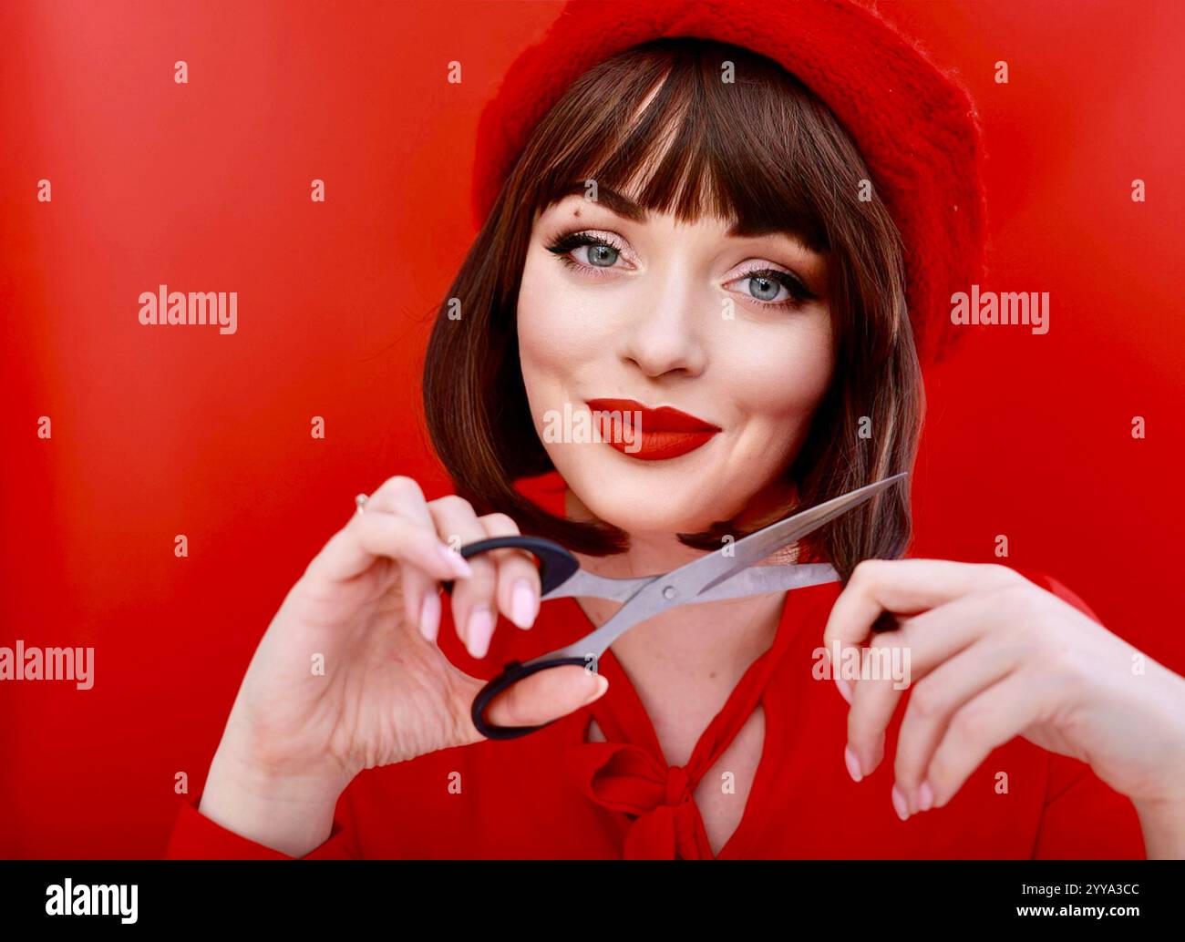 Haircut. Portrait of young woman hairdresser cutting hair with scissors ...