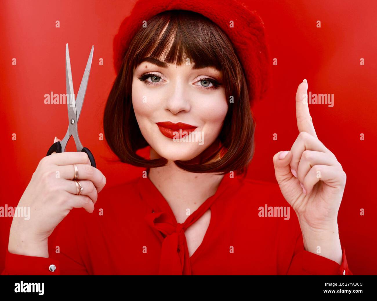 Haircut. Portrait of young woman hairdresser cutting hair with scissors ...