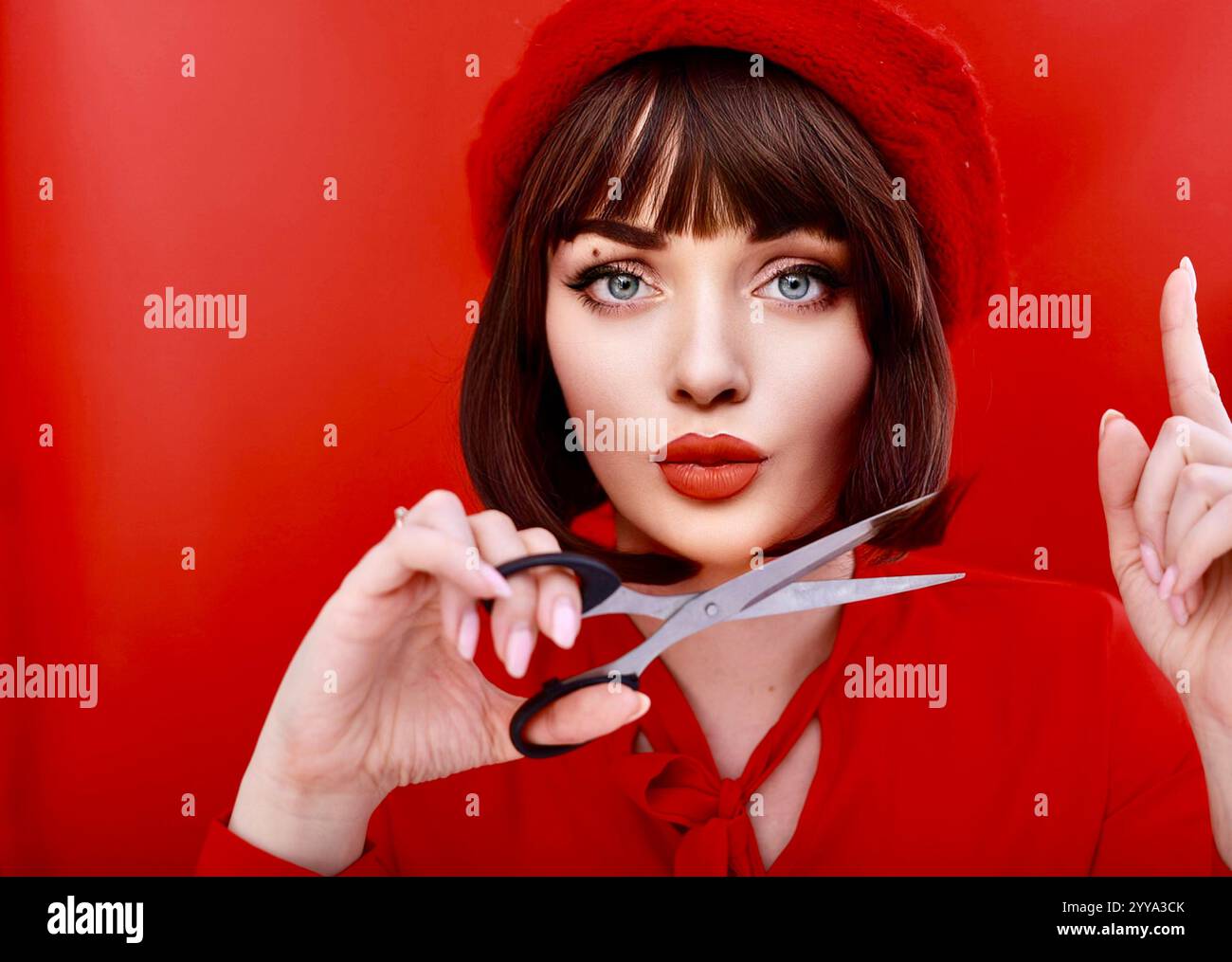 Haircut. Portrait of young woman hairdresser cutting hair with scissors ...