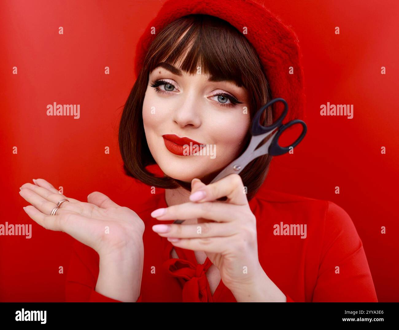 Haircut. Portrait of young woman hairdresser cutting hair with scissors ...