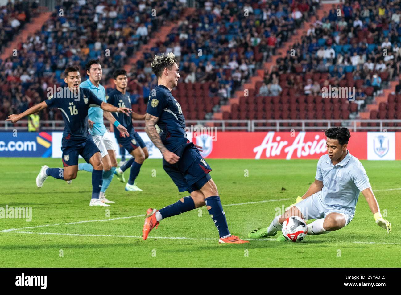 Ly Heng Reth #22 of Cambodia and Nicholas Mickelson (C) of Thailand ...