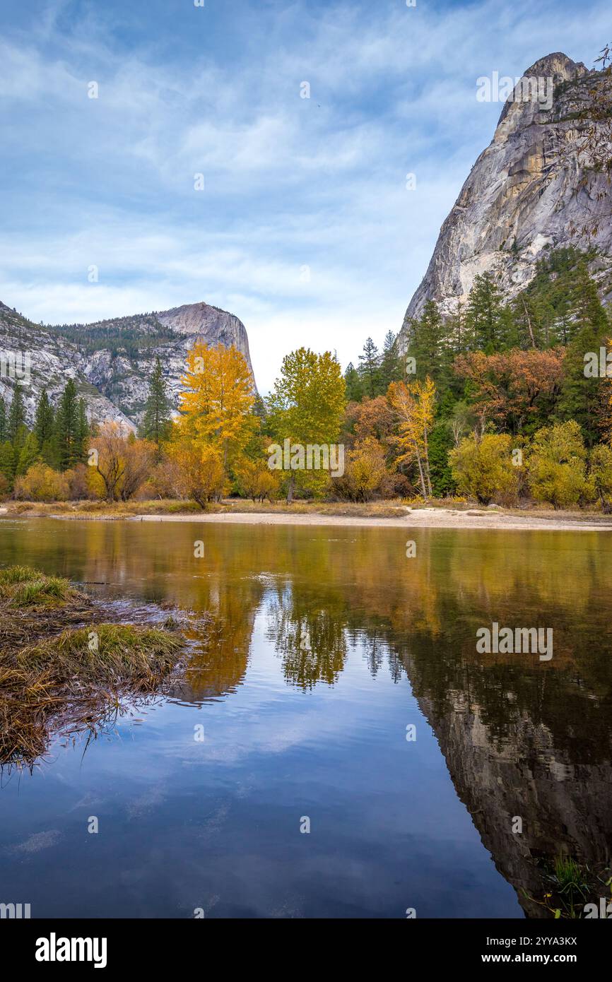 Vibrant fall foliage reflects on the calm waters of Mirror Lake ...