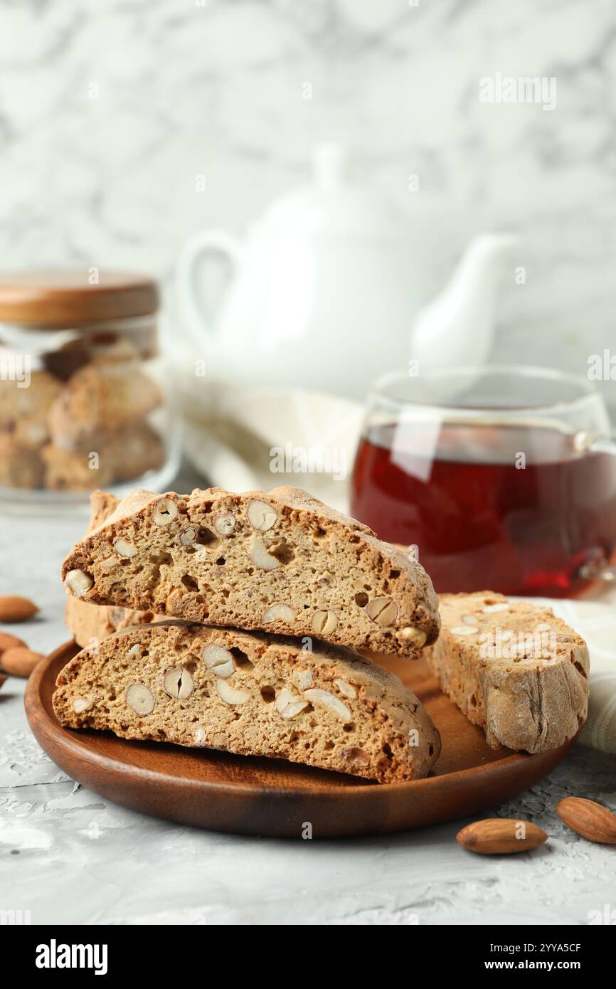 Traditional Italian almond biscuits (Cantucci) on grey textured table ...